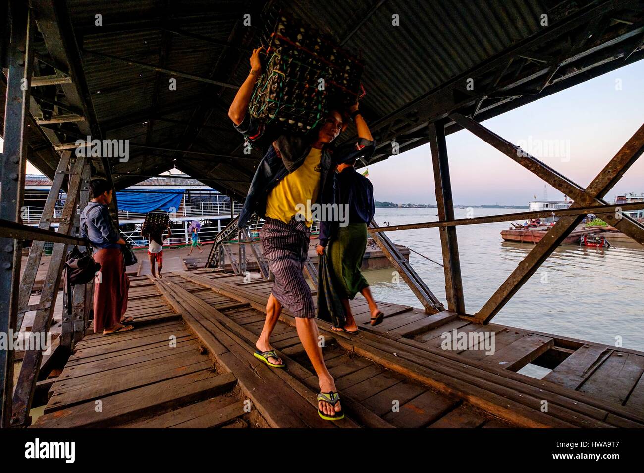 Myanmar, Yangon, old city, Unloading boats along Yangon river Stock ...