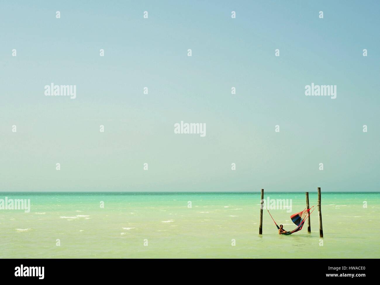 Mexico, Quintana Roo, Isla Holbox, man in a hamac in the wind in green ...