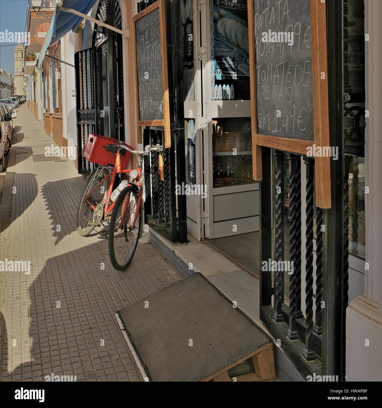 Bicycle at the door of a store Stock Photo - Alamy
