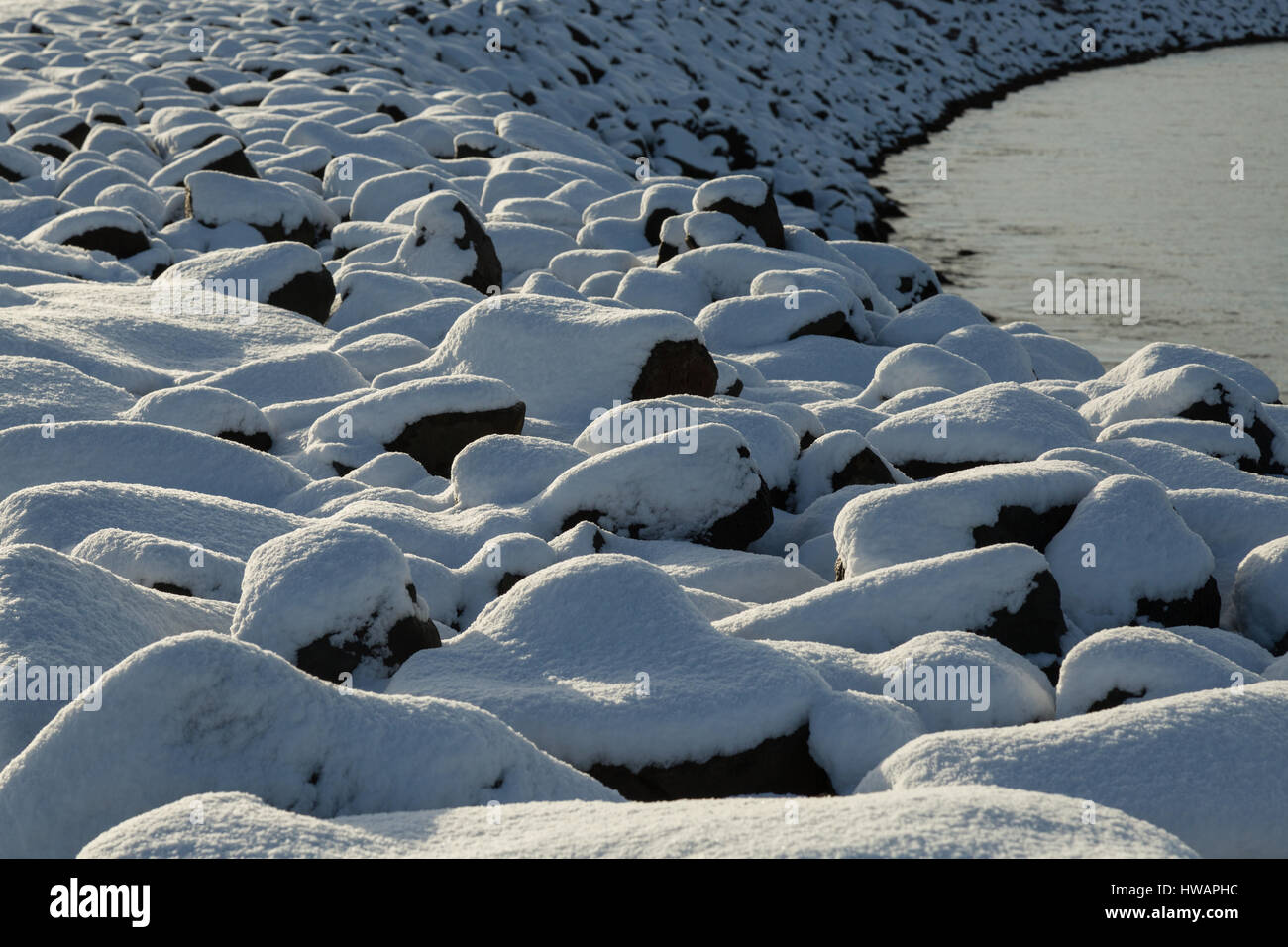 snow-covered rocks along the coast of Rejkjavik, Iceland Stock Photo ...
