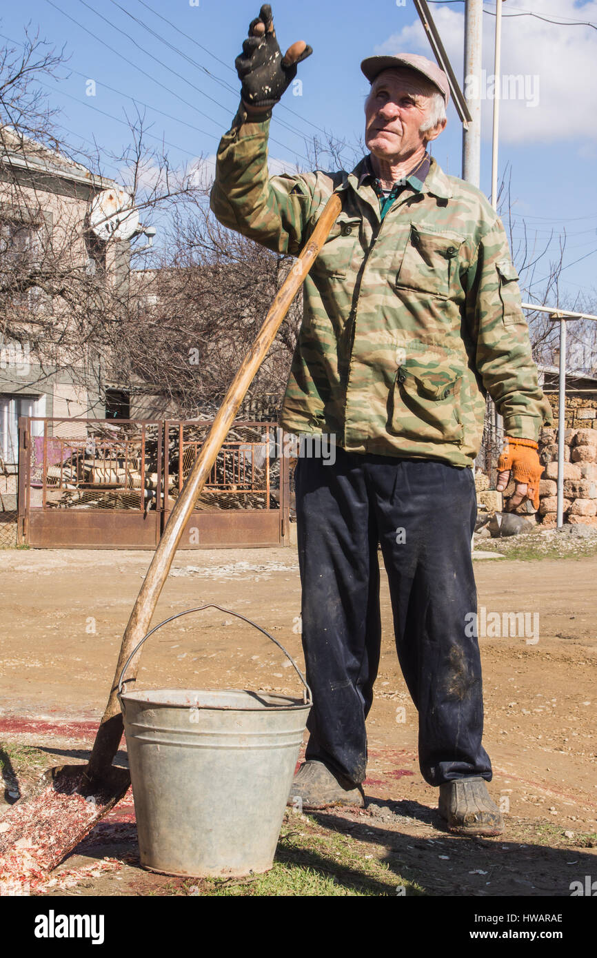 Krasnodar, Russia - March 4, 2017: Elderly Russian farmer with bucket ...