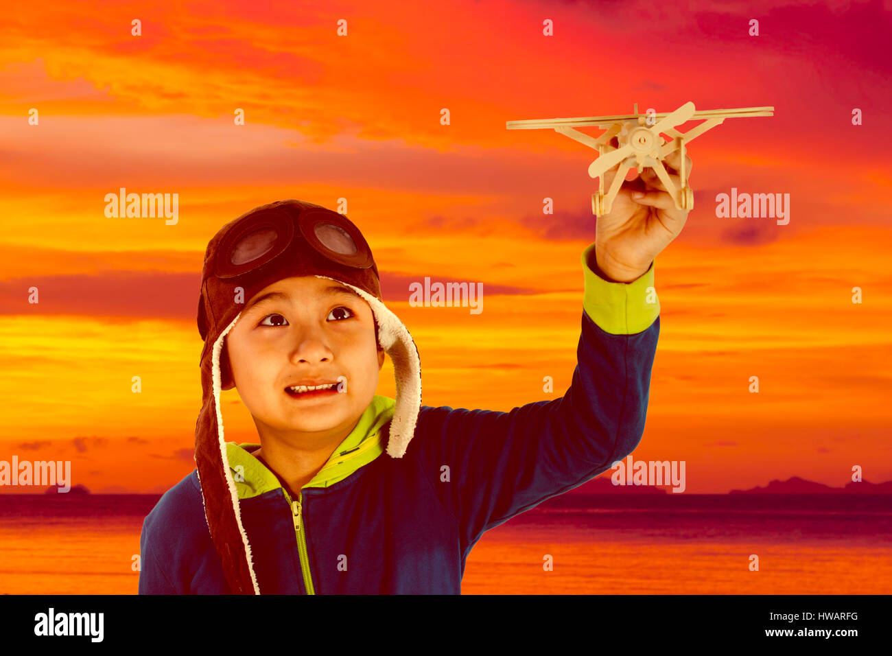 Asian Chinese Boy Playing with Wooden Airplane against Dusk Background ...