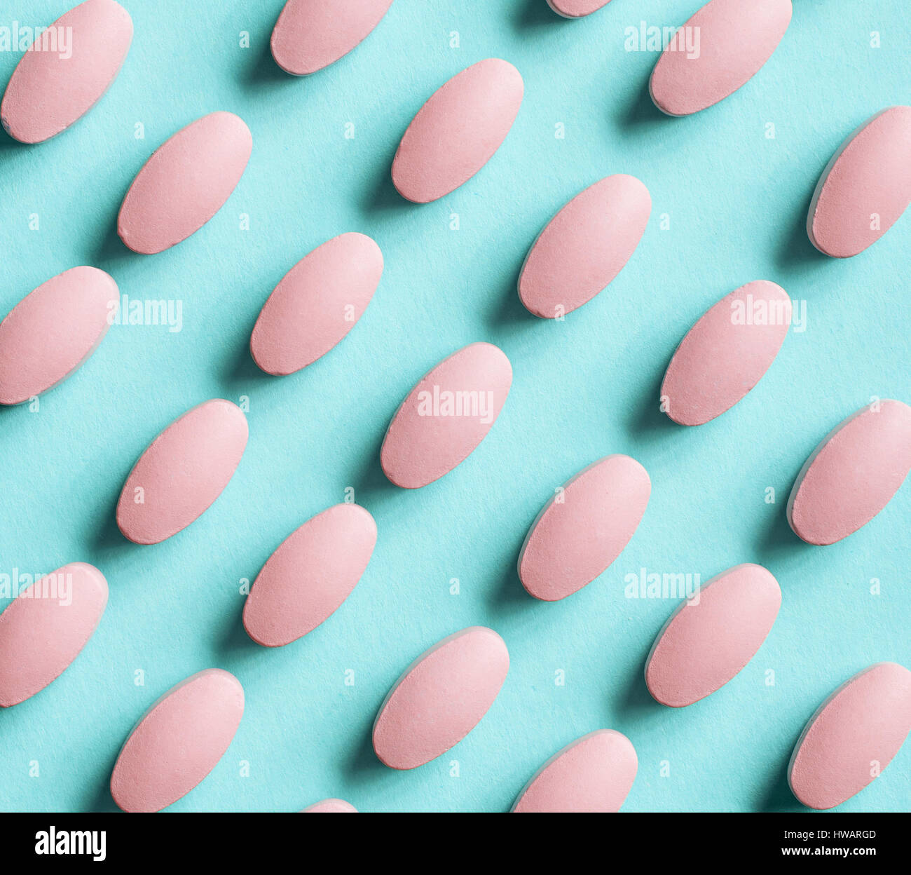 pink pills on blue background, top view Stock Photo - Alamy