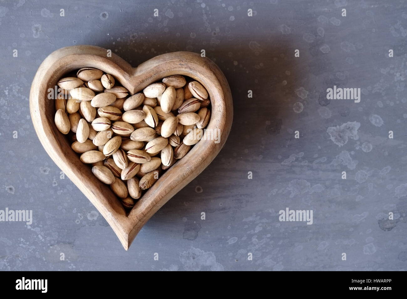 Close-Up of Pistachios in Wooden Heart-Shaped Bowl – Healthy Eating ...
