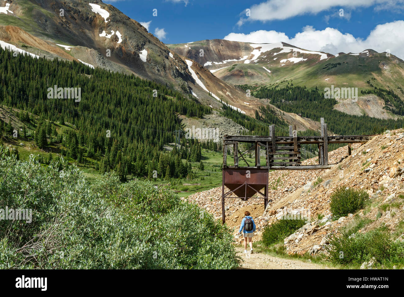 Hiker at ruins of Shoe Basin Mine and surrounding mountains above Peru ...