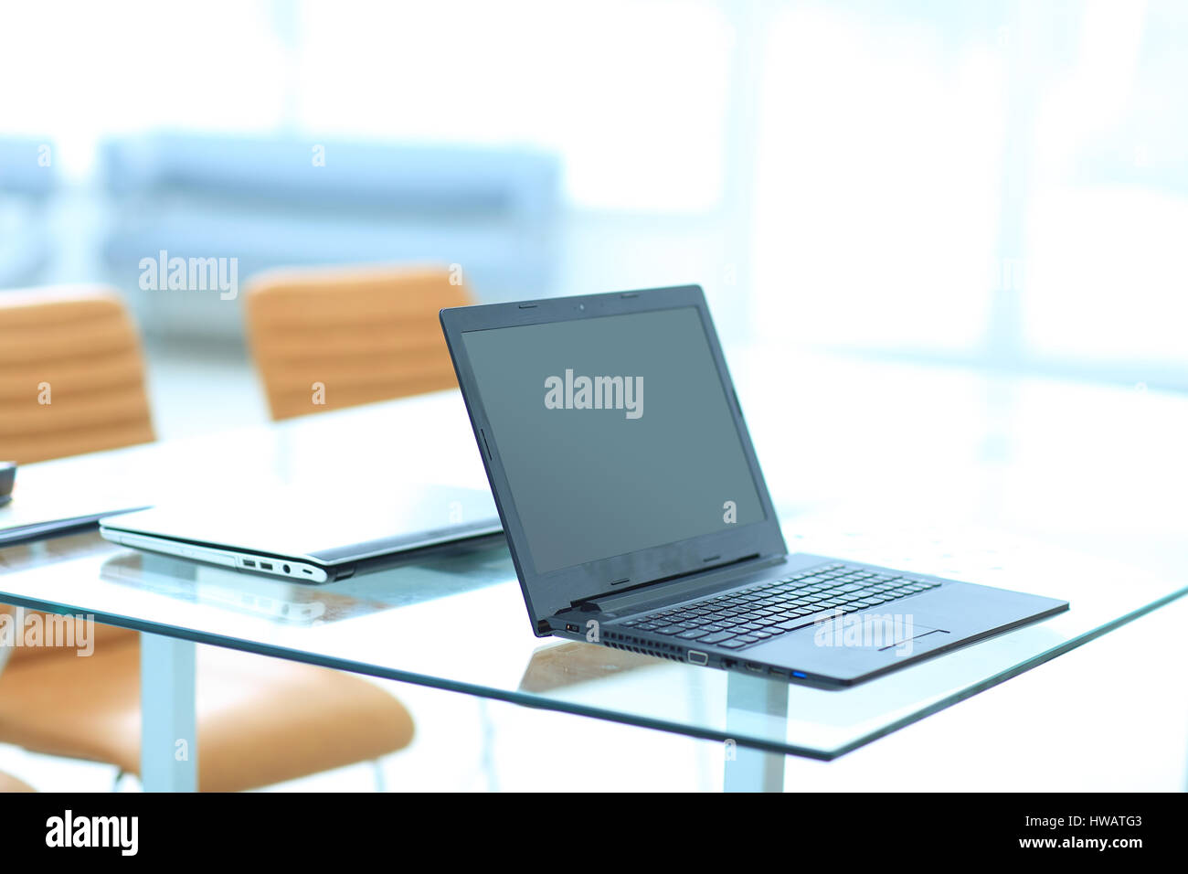 Laptop on the table in the office Stock Photo - Alamy