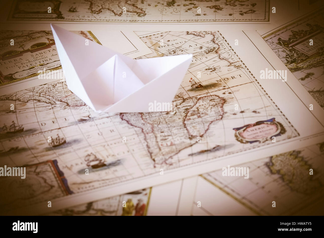 Paper boat on ancient map Stock Photo - Alamy