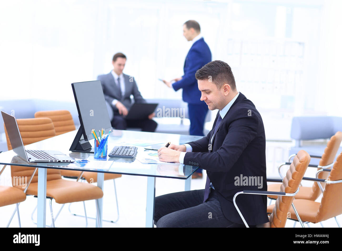 Employee looking at computer monitor during working day in office Stock ...