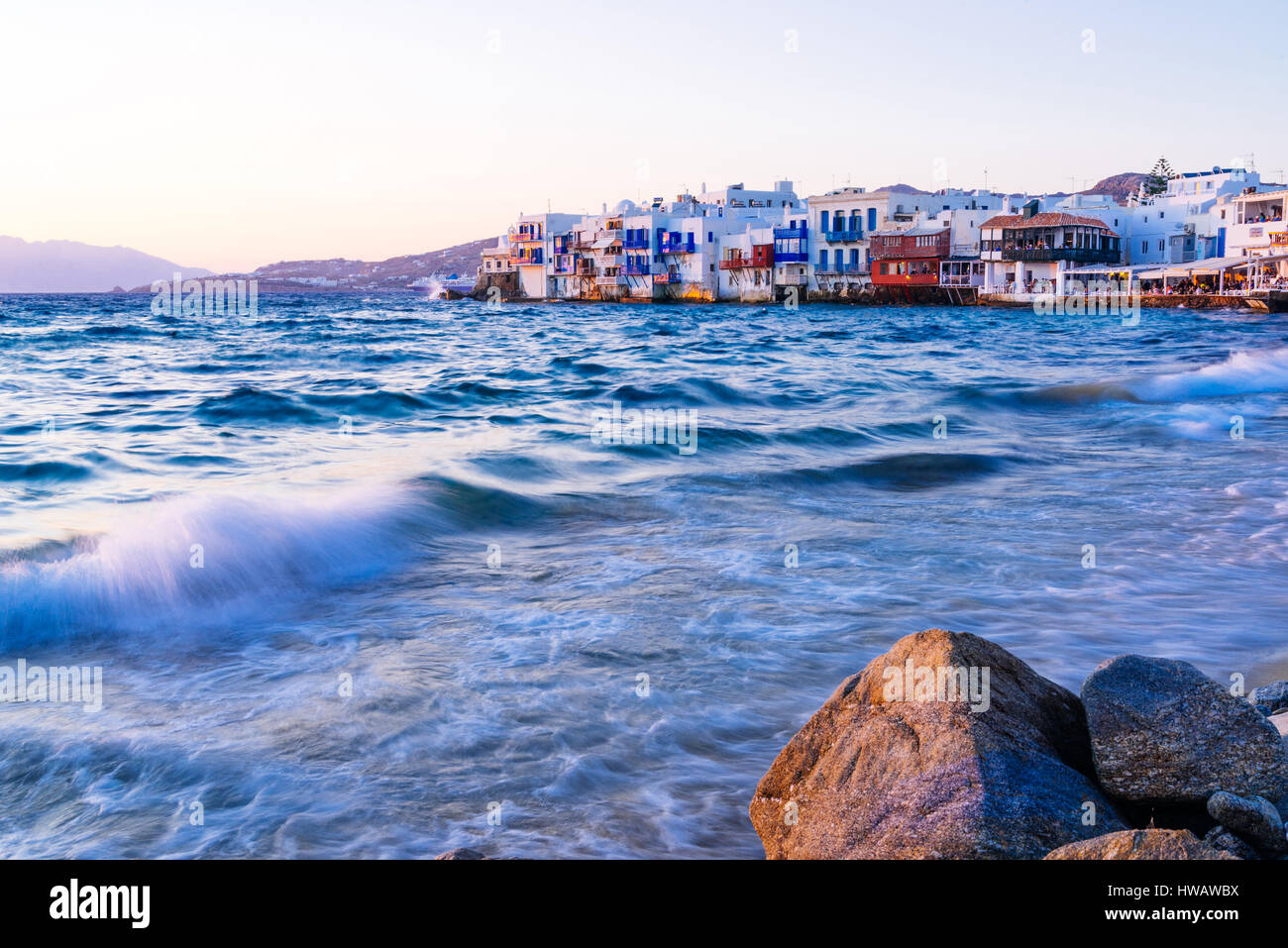 Little Venice in Mykonos at sunset with rolling waves Stock Photo - Alamy