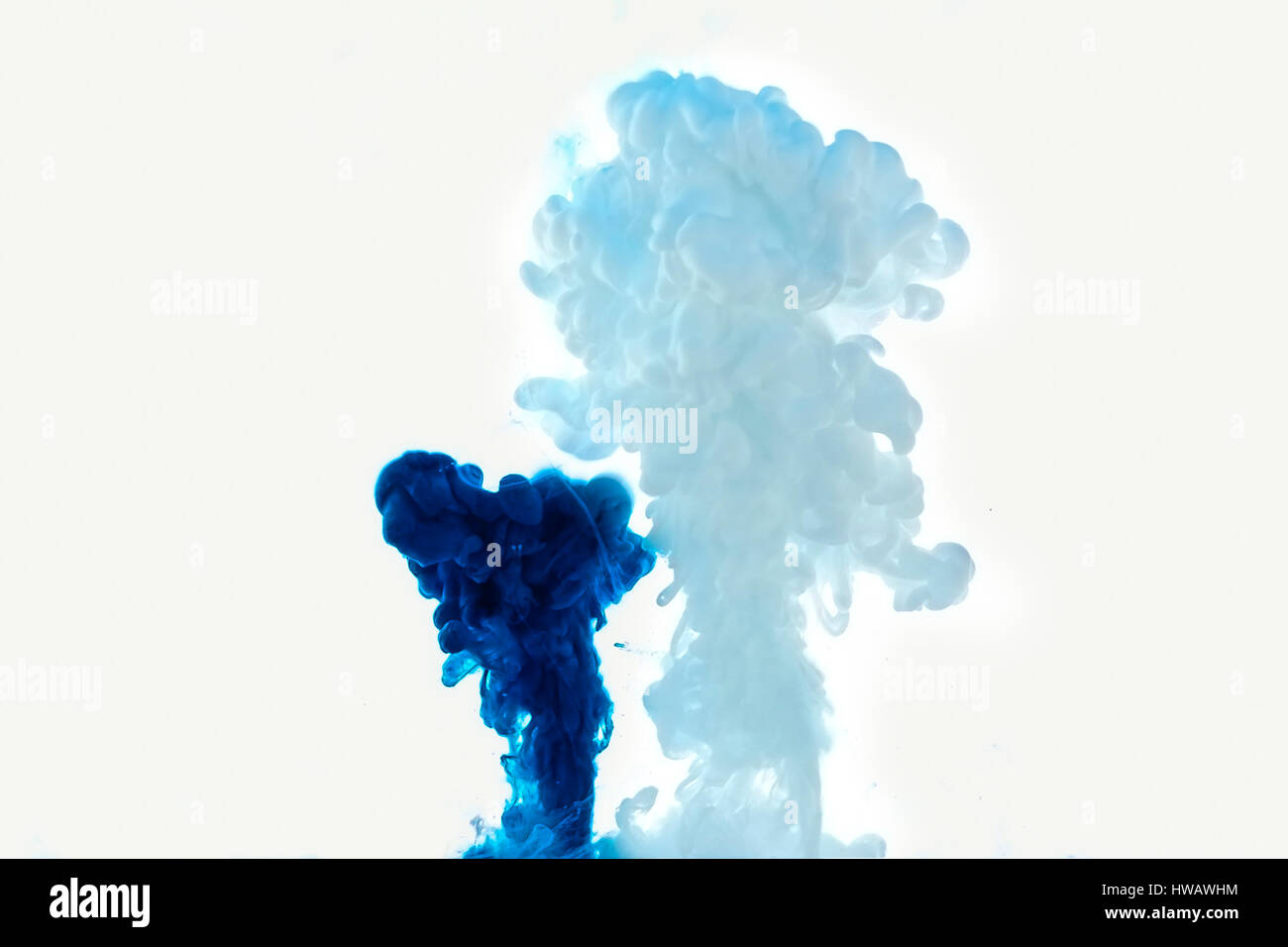 Multicolored swirling drop of ink in water creates abstract backgrounds ...