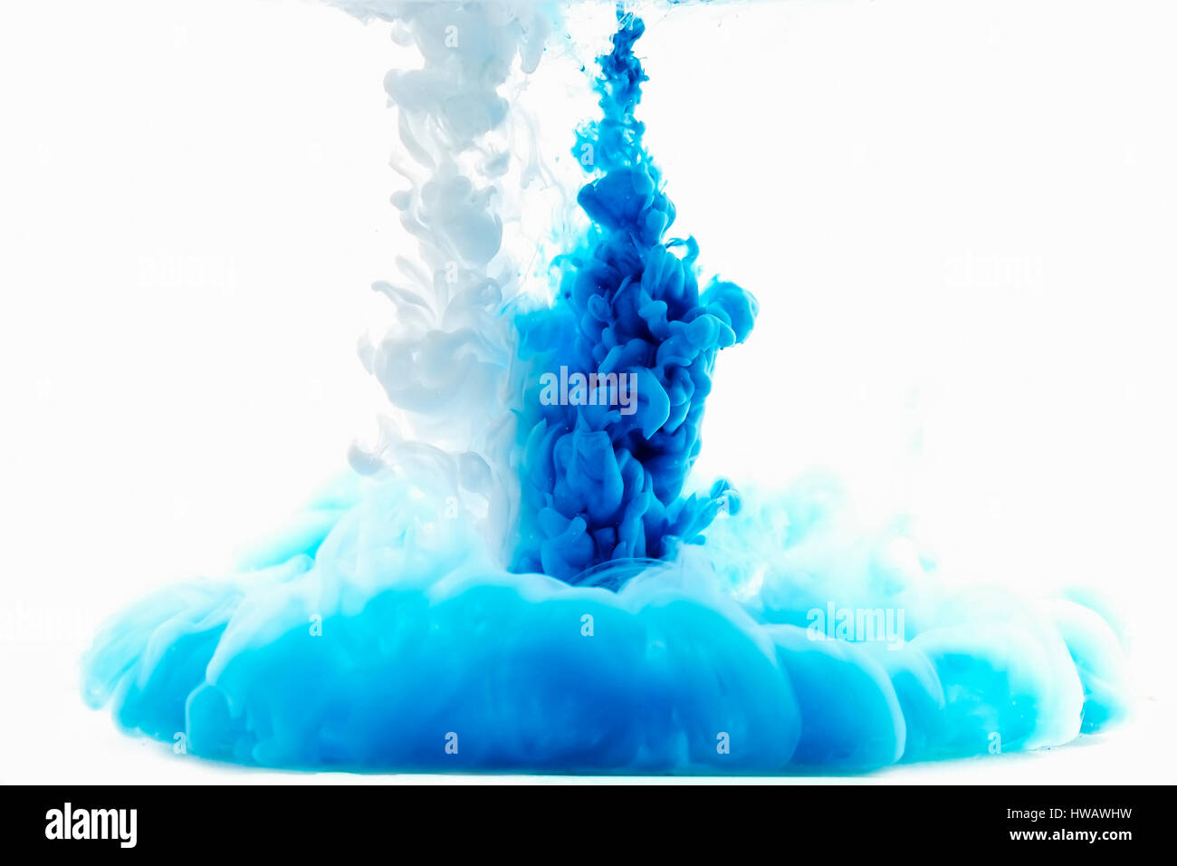 Multicolored swirling drop of ink in water creates abstract backgrounds ...