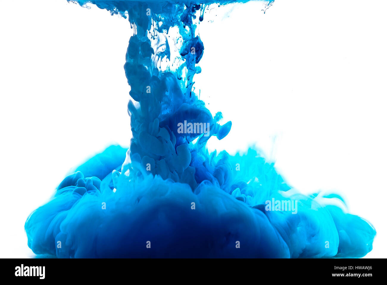 Multicolored swirling drop of ink in water creates abstract backgrounds ...