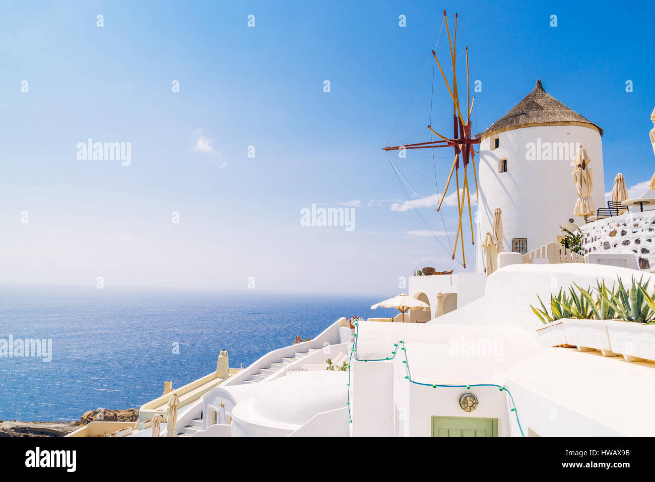 Famous Oia village windmill at sunset, Santorini island, Greece Stock ...