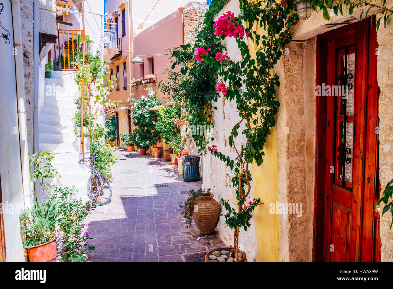 Colorful streets of old Chania town with blooming flowers and ancient ...