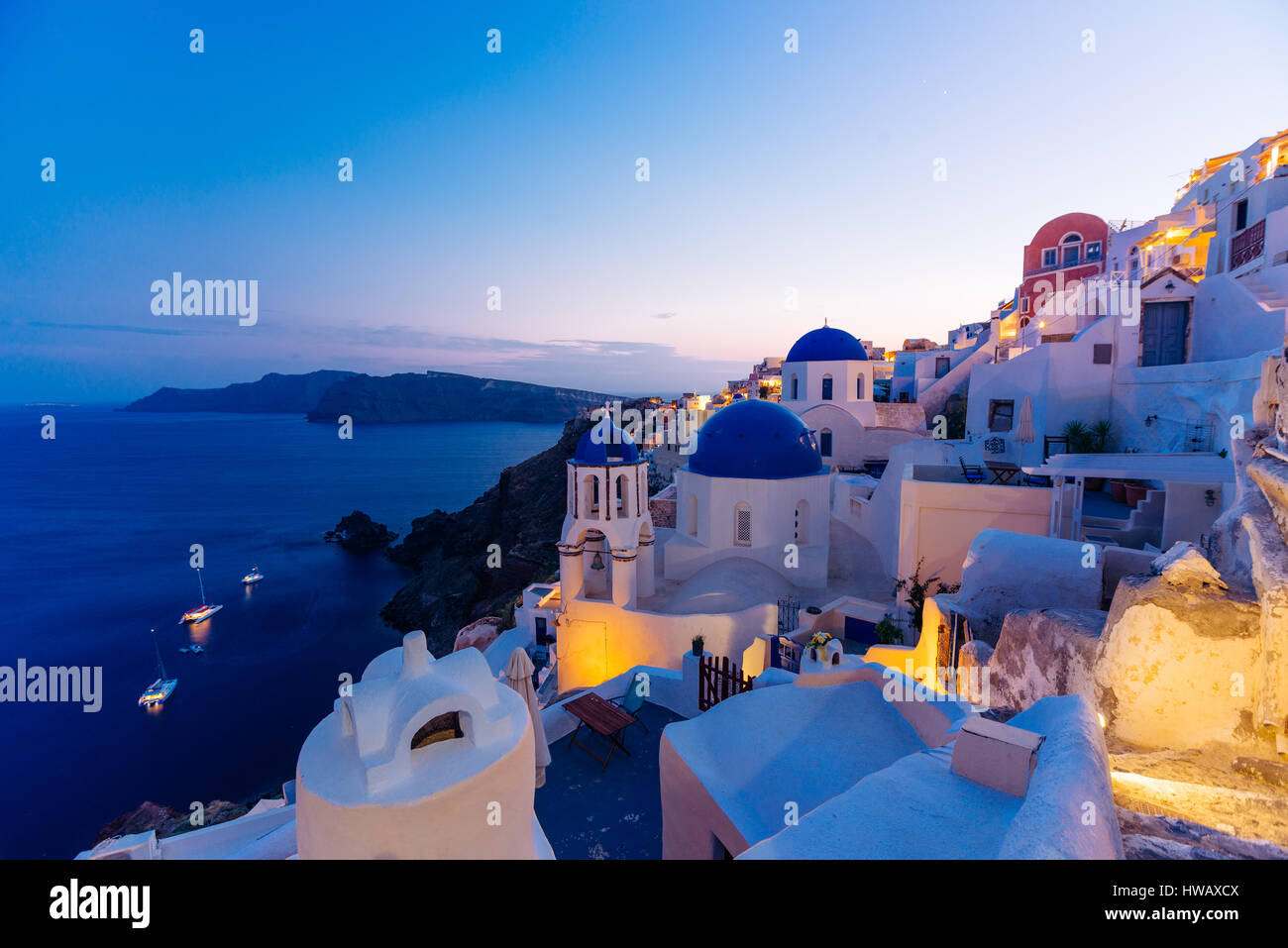 Famous Oia blue dome churches at twilight, Santorini, Greece Stock ...