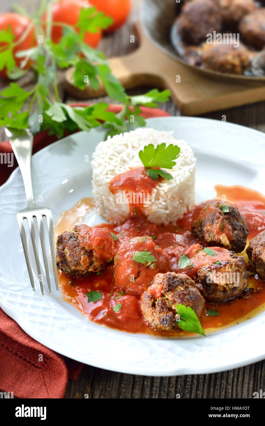 Crispy roasted meatballs with basmati rice and tomato sauce Stock Photo ...