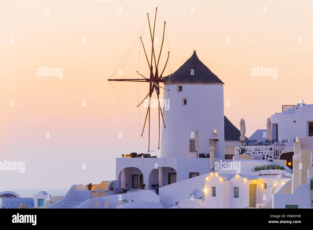 Summer sunset behind windmill in Oia village on Santorini island ...