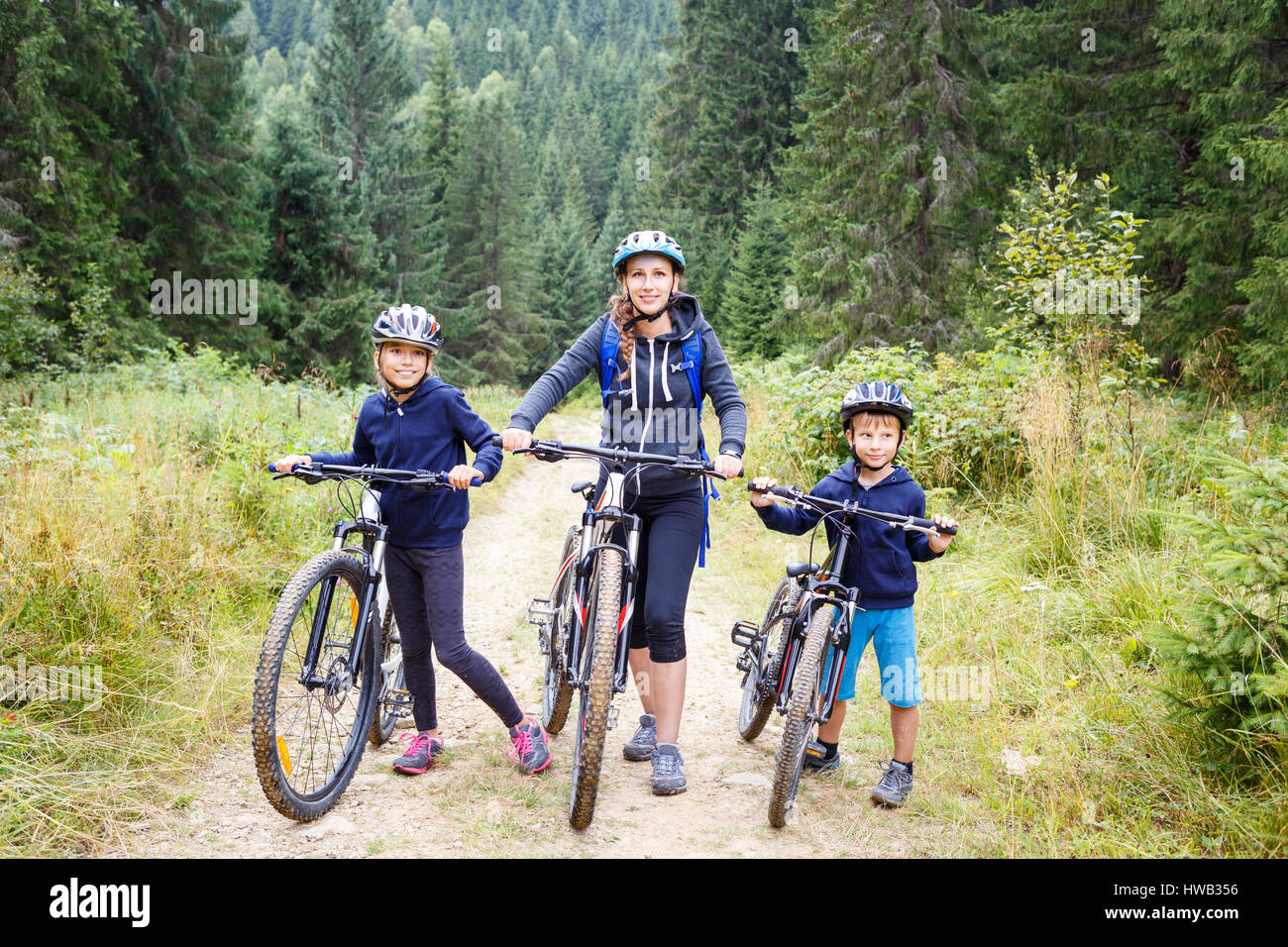 Family cycling woods hi-res stock photography and images - Alamy