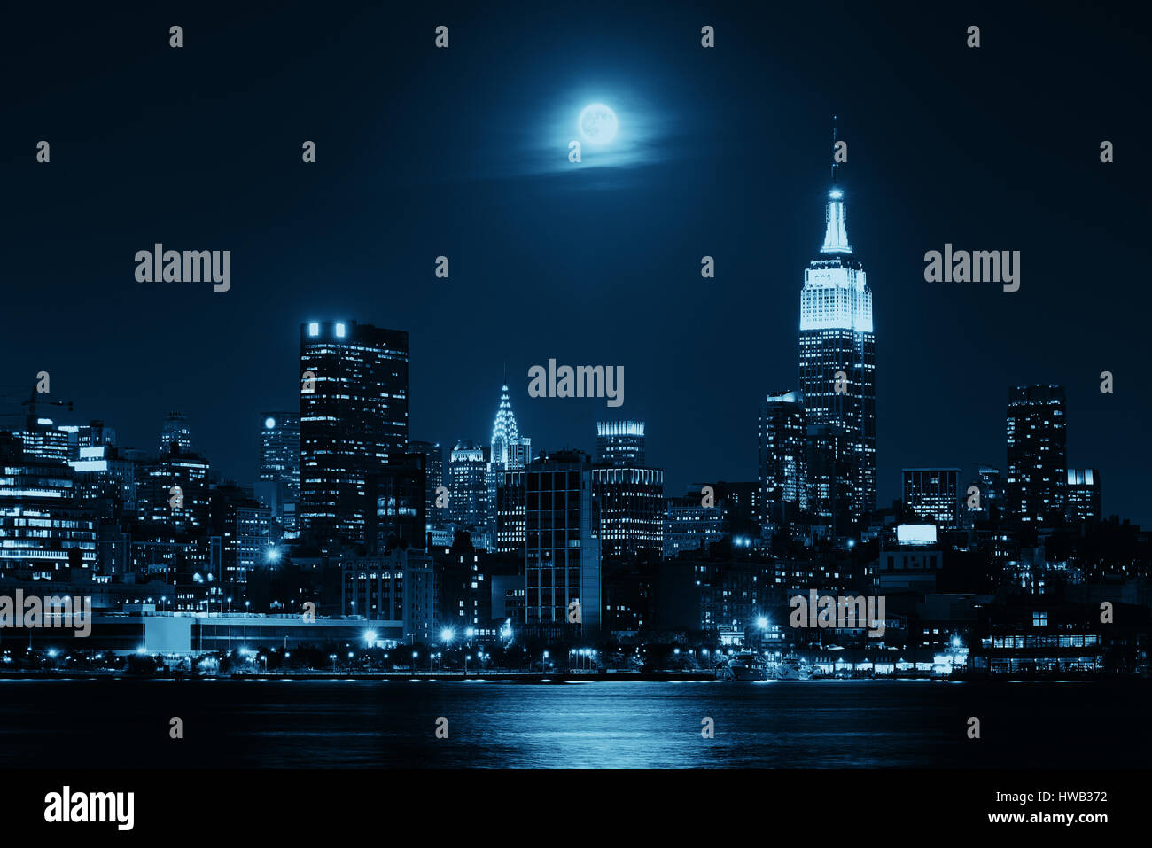 Moon rise over midtown Manhattan with city skyline at night Stock Photo ...