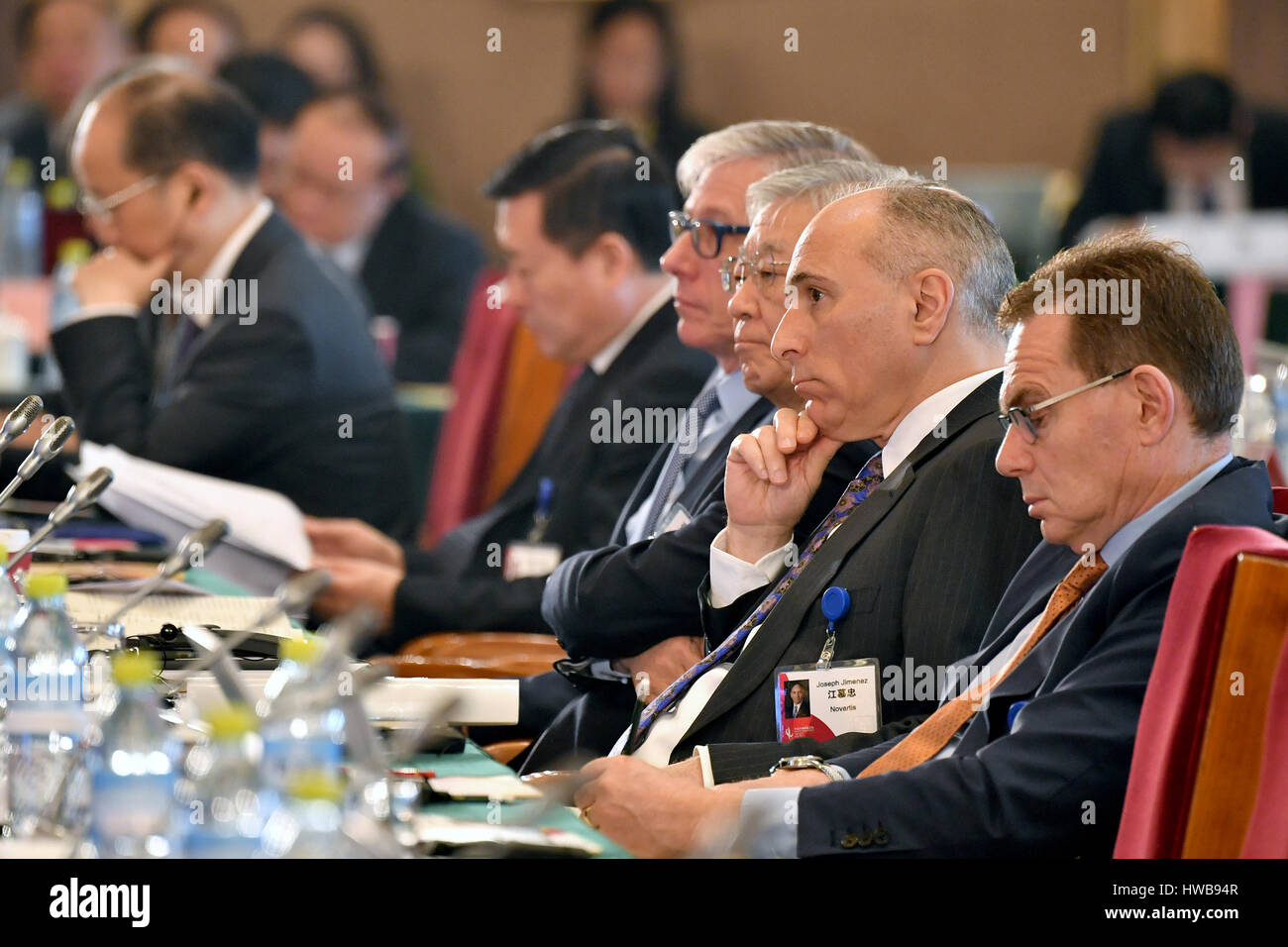 Beijing, China. 19th Mar, 2017. Attendees listen to the speech during ...