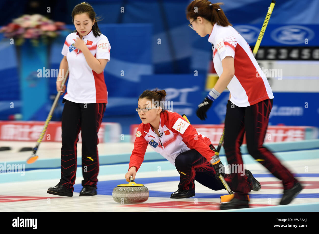 Beijing, China. 19th Mar, 2017. Wang Bingyu (C) of China throws a stone ...