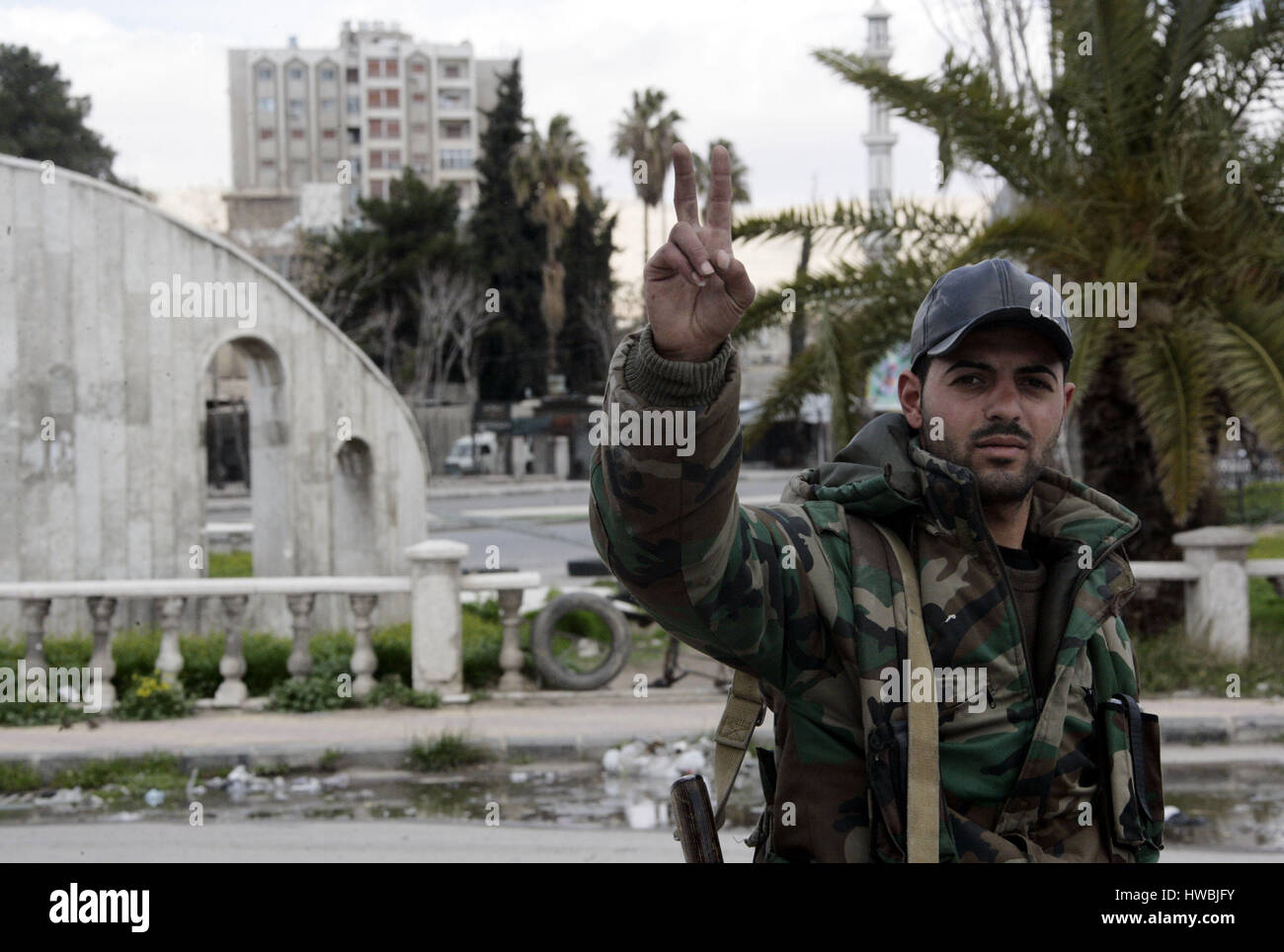 Damascus, Syria. 20th March, 2017. A Syrian soldier flashes the victory ...