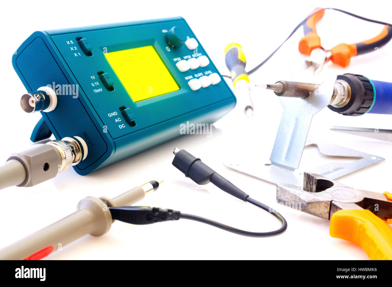 Modern digital signal oscilloscope and tools isolated on white ...