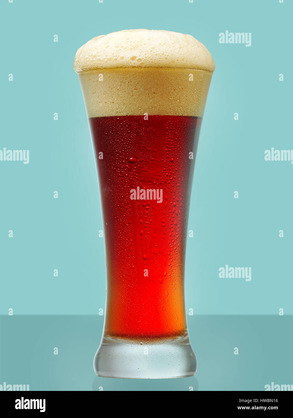 glass of beer on blue background Stock Photo - Alamy