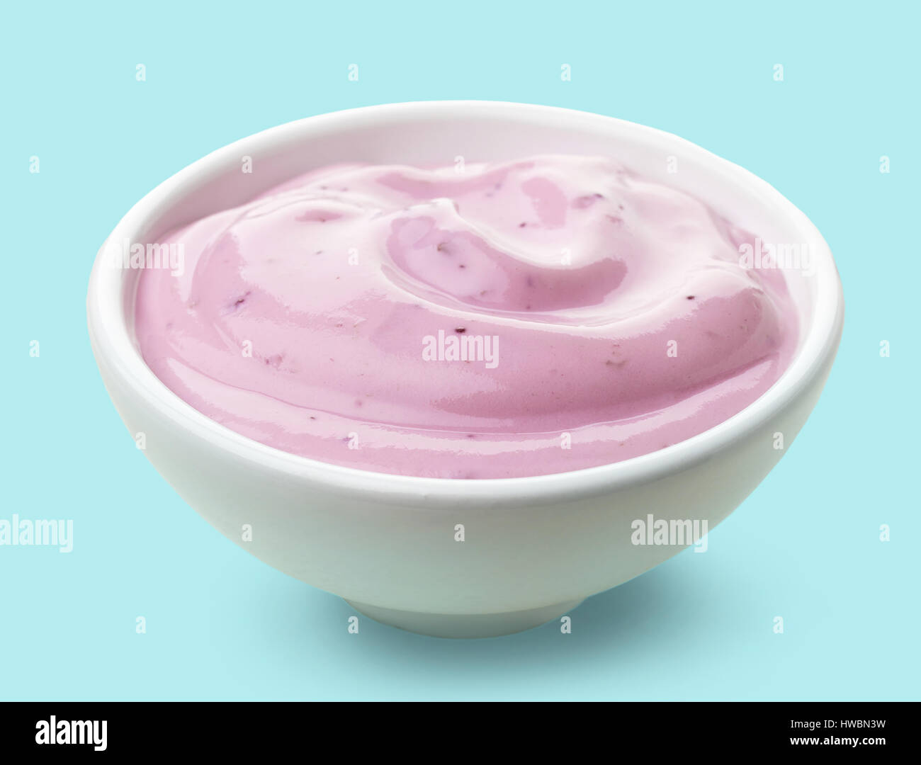 bowl of pink fruit yogurt on blue background Stock Photo - Alamy