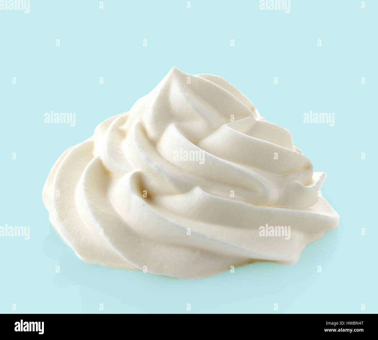 whipped cream isolated on a blue background Stock Photo - Alamy