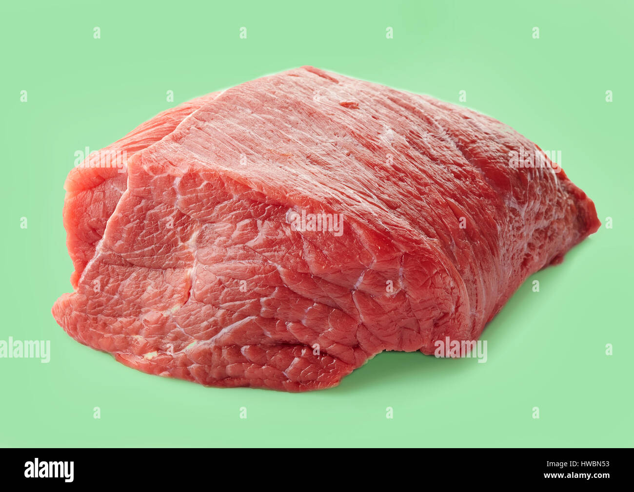 fresh raw meat on a green background Stock Photo - Alamy