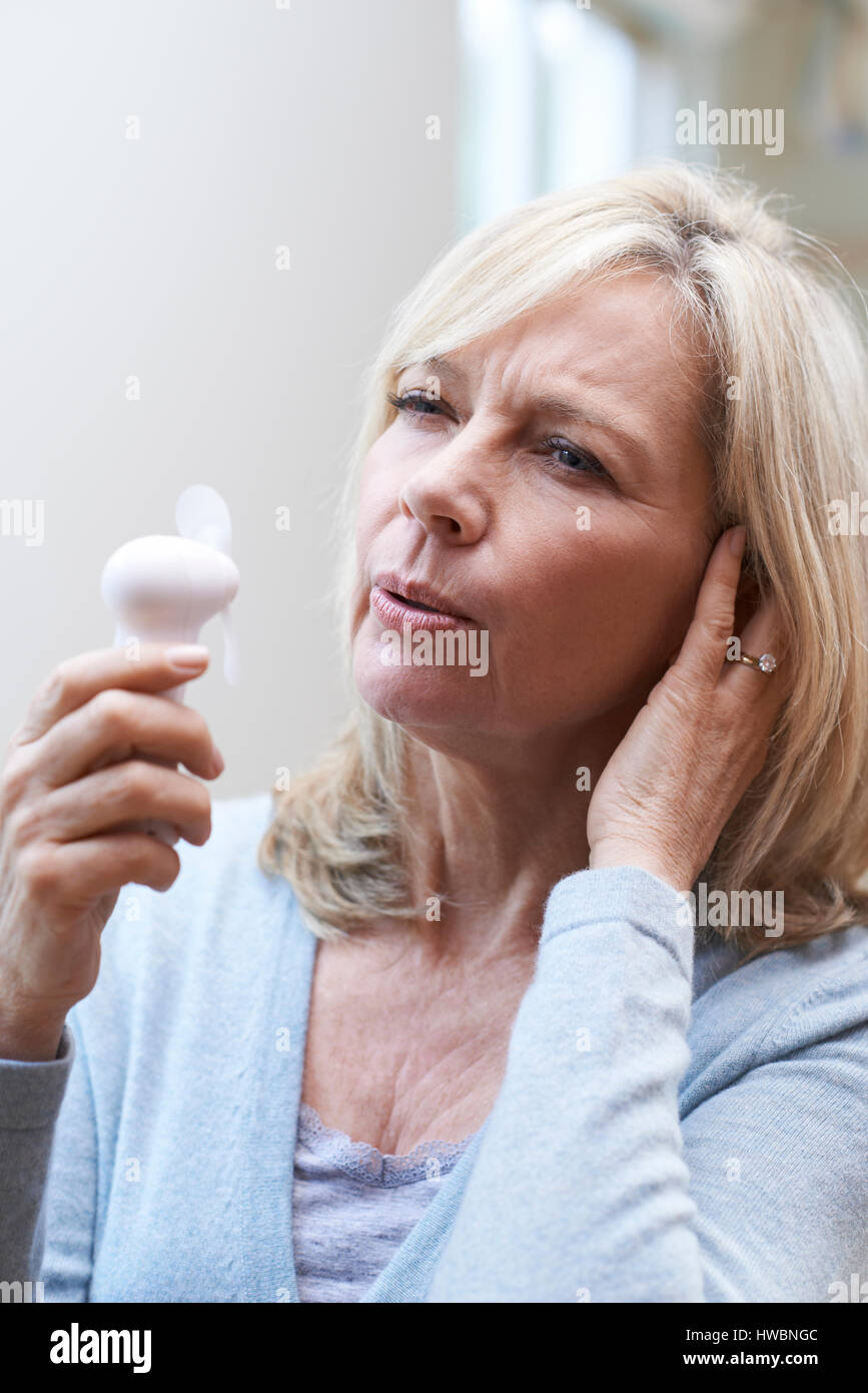 Mature Woman Experiencing Hot Flush From Menopause Stock Photo - Alamy