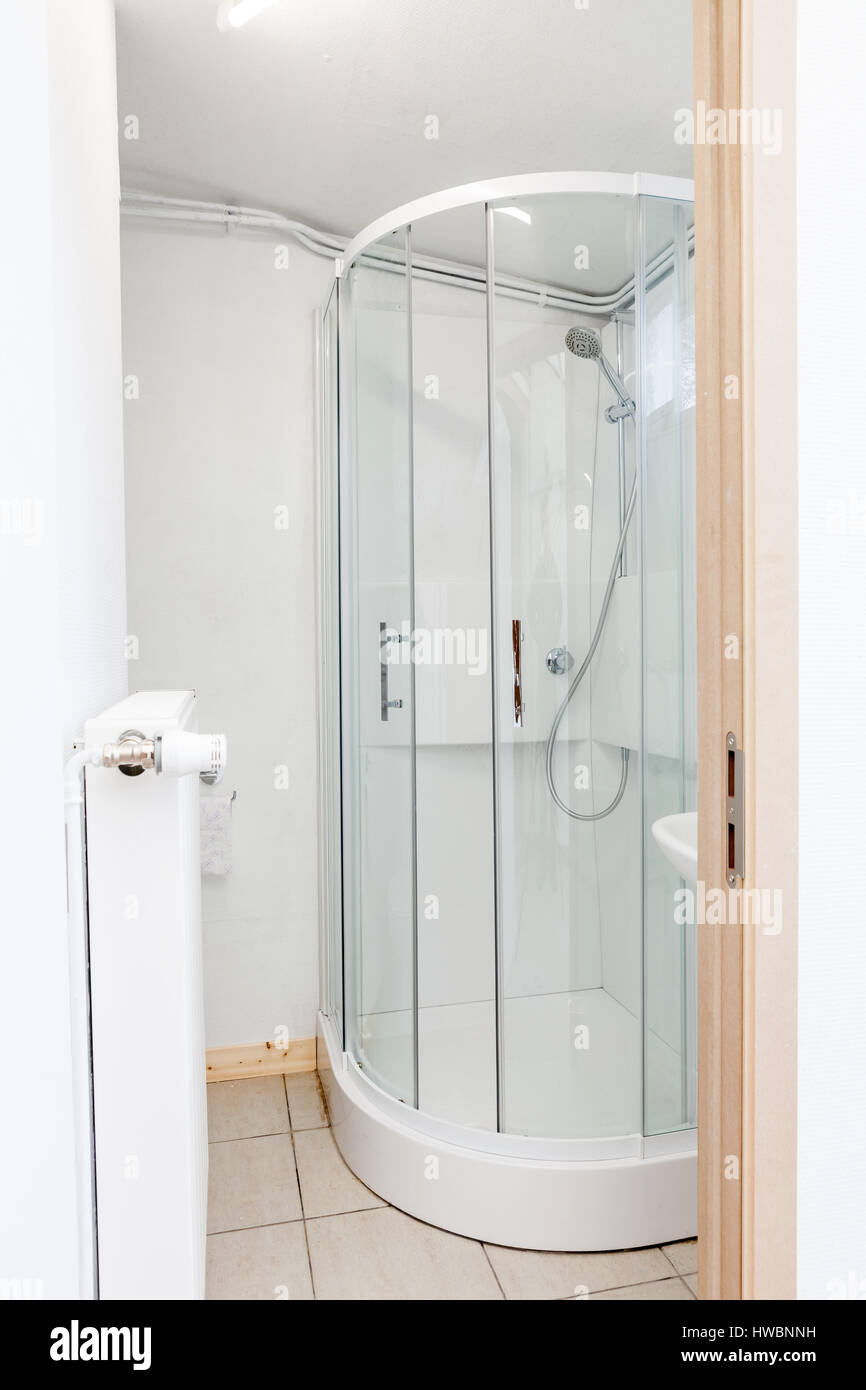 in a small place, there is a shower booth in the corner of the bathroom ...