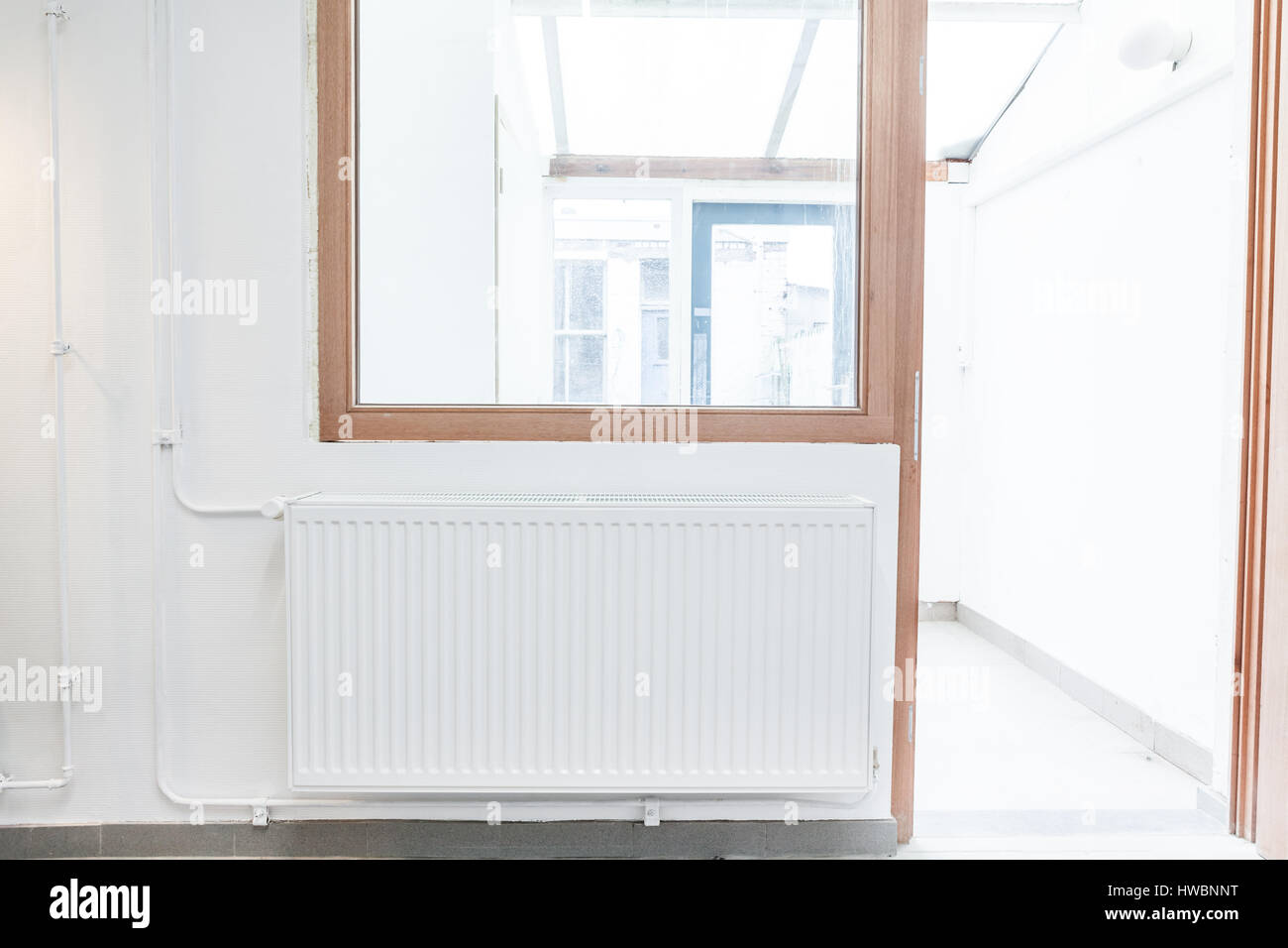 on concrete wall hang an radiator in working in the wall Stock Photo ...