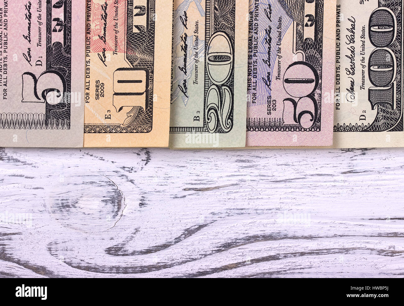 US dollars on old white wooden plank Stock Photo - Alamy