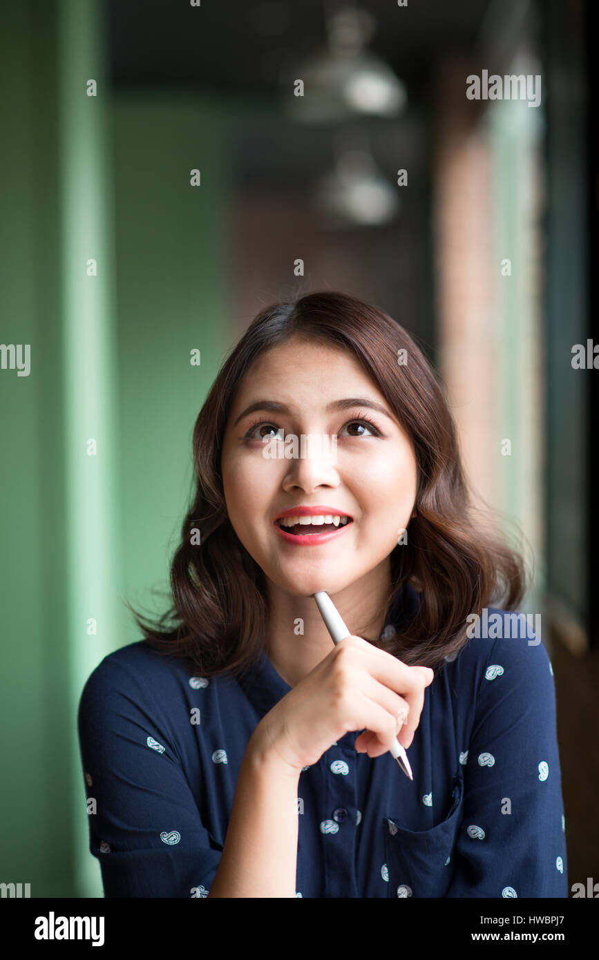 Woman thinking writing in book hi-res stock photography and images - Alamy