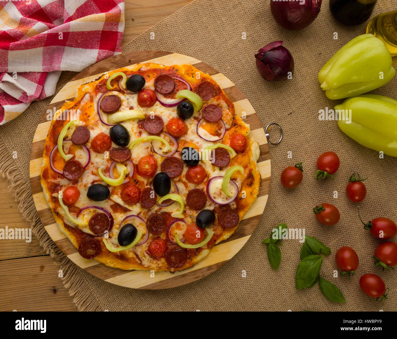 rustic pizza with sausage, mozzarella, tomato, pepper, onion and olives ...