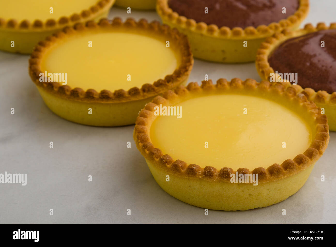 round sweet vanilla tart on white table Stock Photo - Alamy