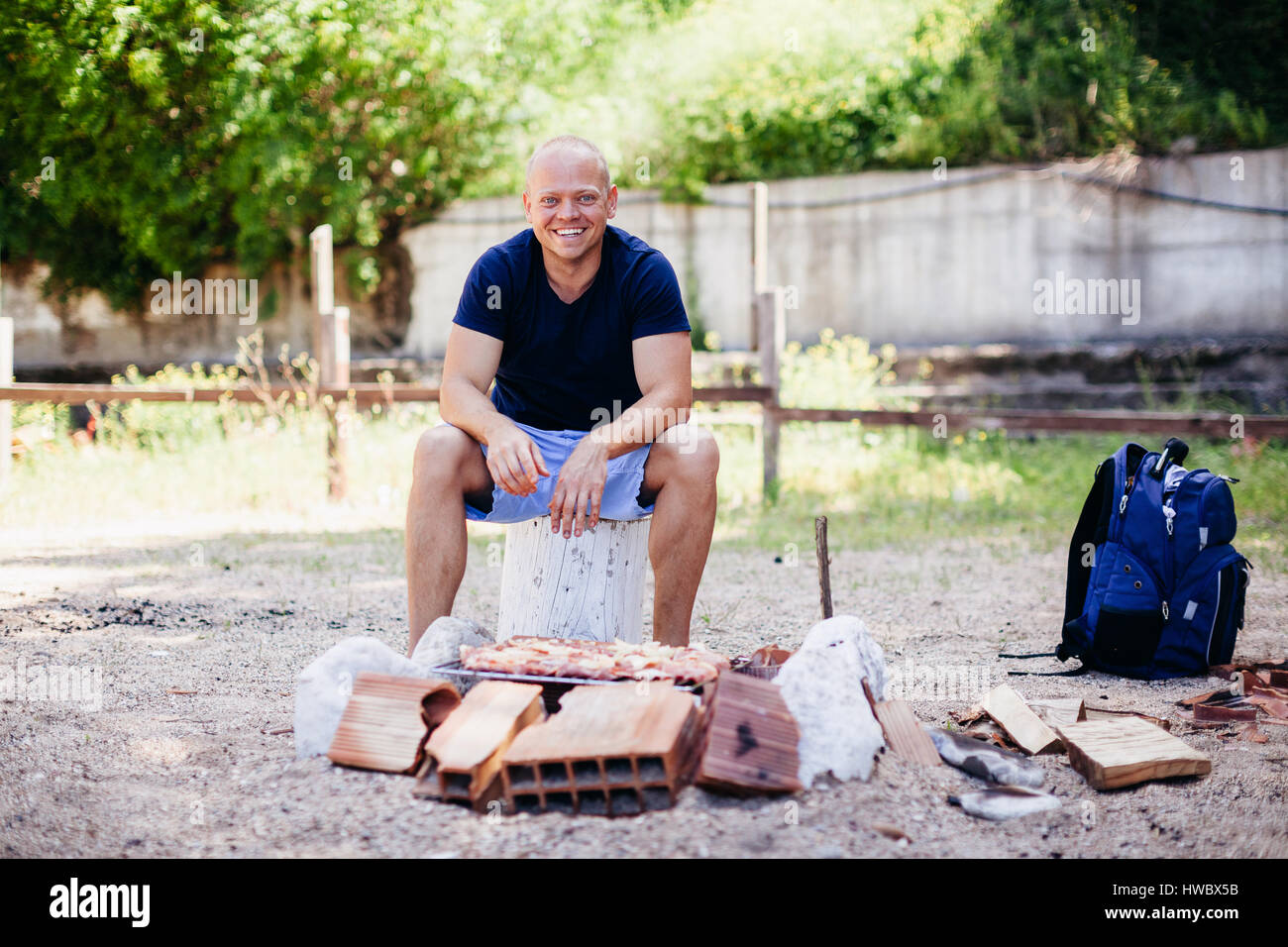 man cooking bbq in forest green park Stock Photo - Alamy