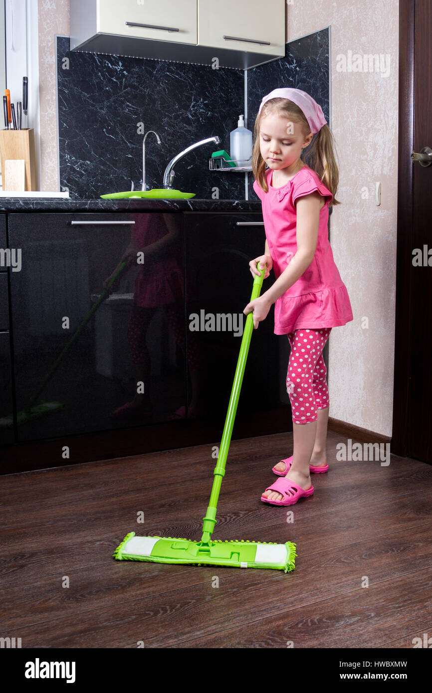 Little girl washes the floor with a mop Stock Photo - Alamy