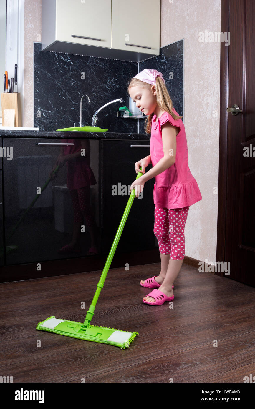 Little girl washes the floor with a mop Stock Photo - Alamy