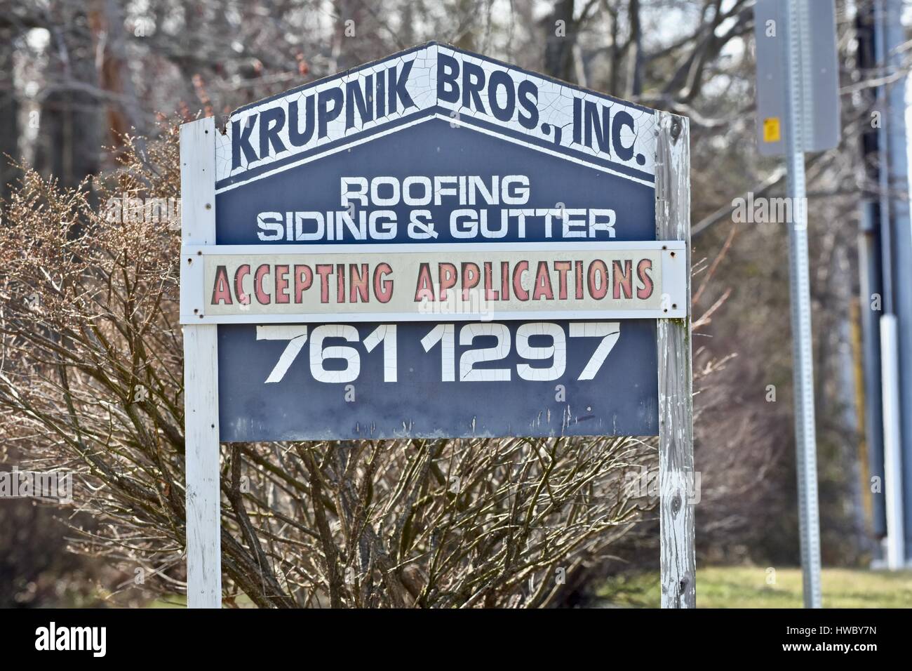 Roofing, siding, & gutter sign Stock Photo - Alamy