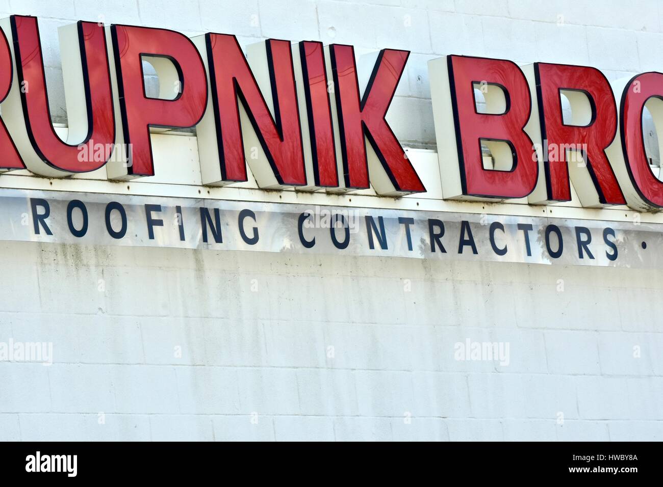 Roofing contractor sign Stock Photo - Alamy
