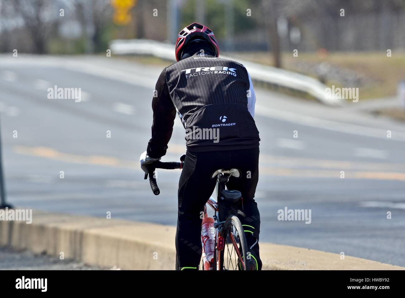 Cyclist riding alongside the road Stock Photo - Alamy