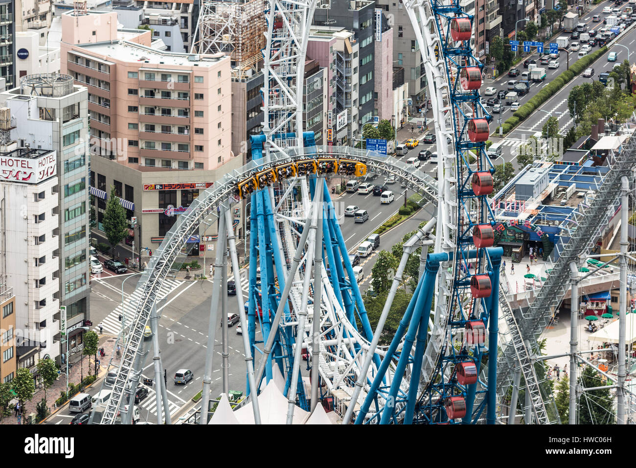 TOKYO, JAPAN - AUGUST 17, 2015: People enjoy a roller coaster ride in ...