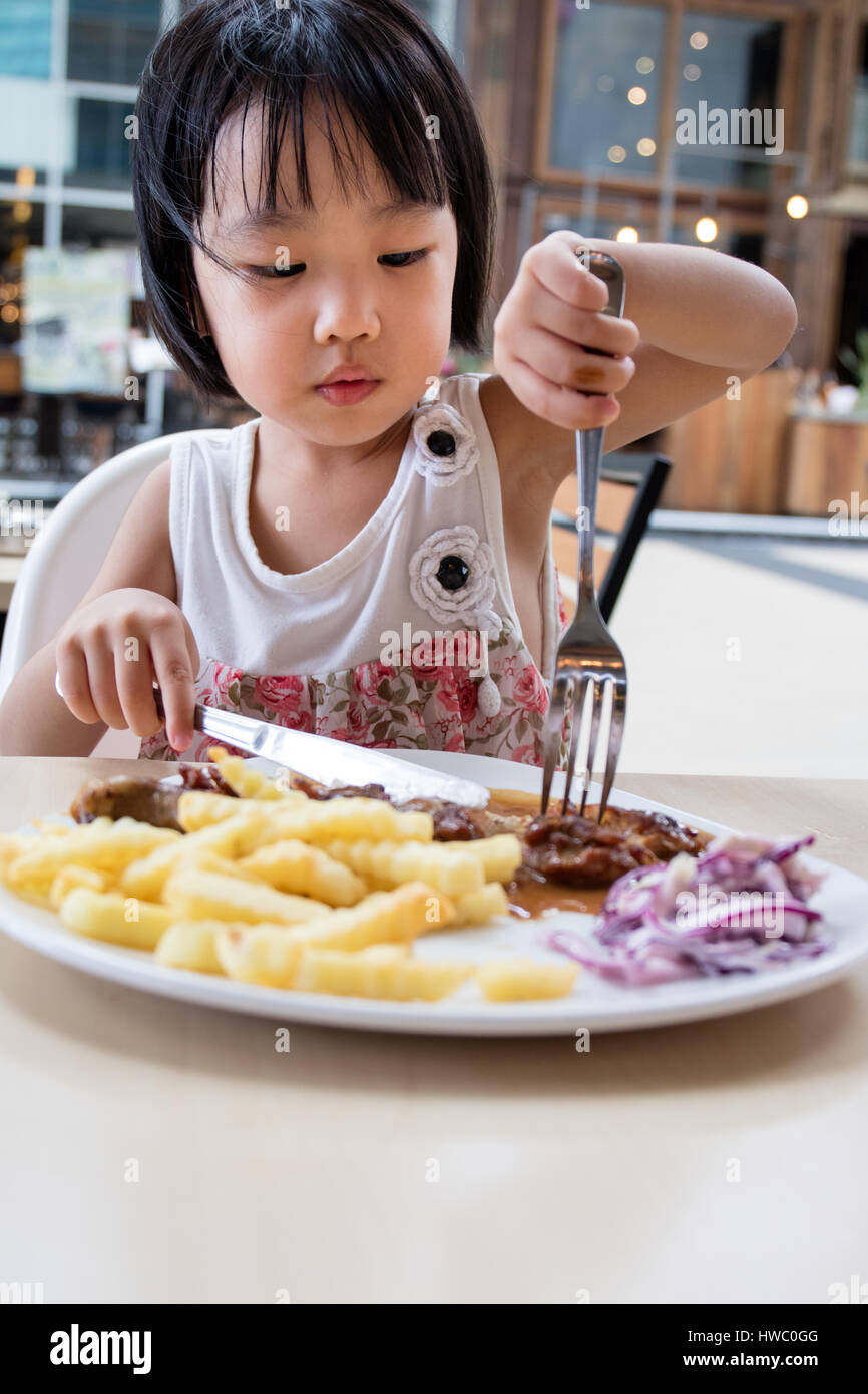 Asian Little Chinese Girl Eating Western Food in Outdoor Cafe Stock ...