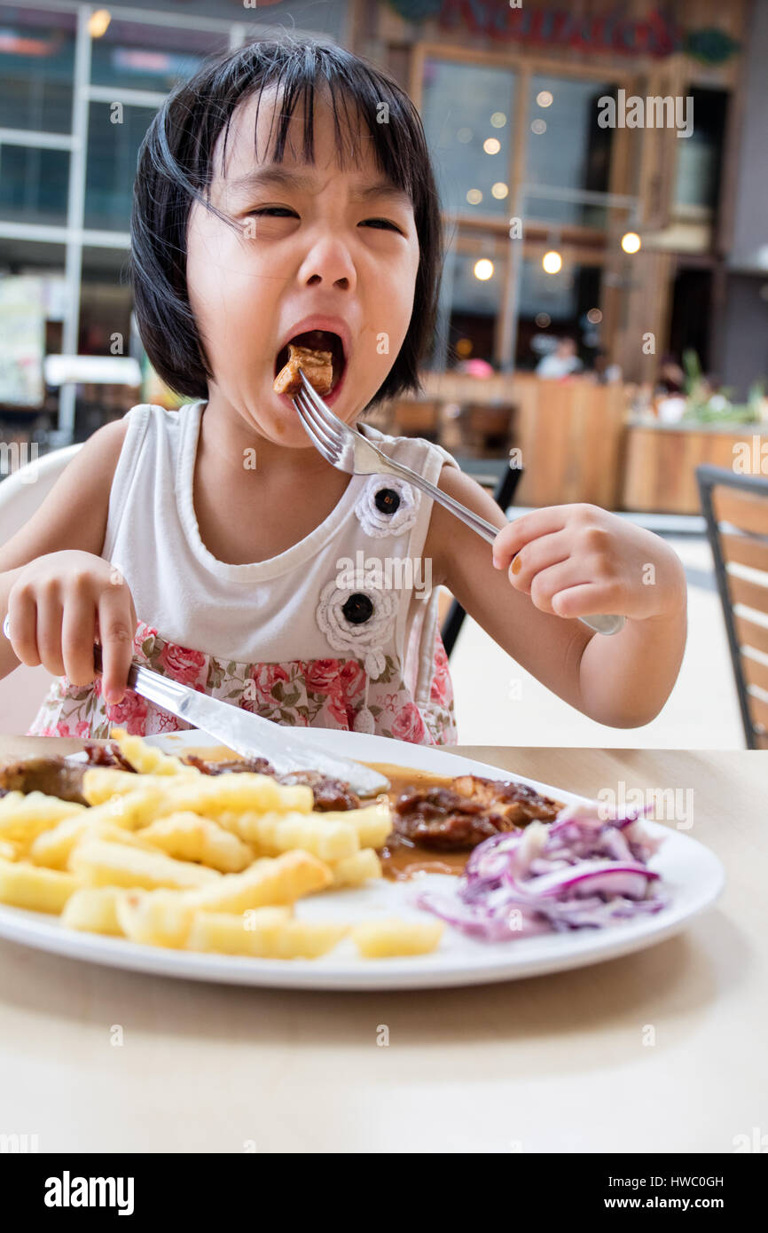 Asian Little Chinese Girl Eating Western Food in Outdoor Cafe Stock ...