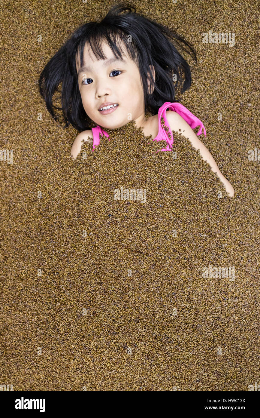Children child buried sand hi-res stock photography and images - Alamy