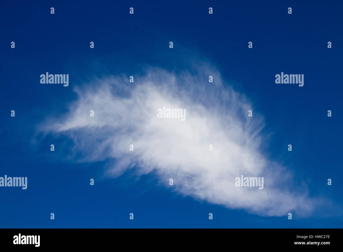 A single cloud floating in a blue sky China Stock Photo - Alamy