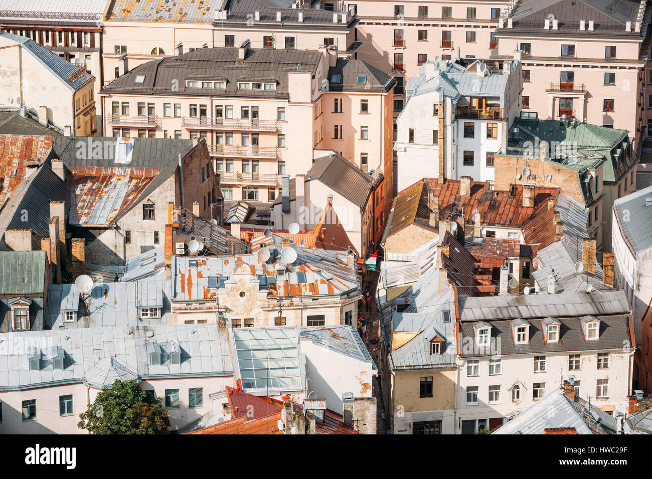 Riga, Latvia. Top View On Old Rusty Roofs Old Houses In Summer Sunny ...